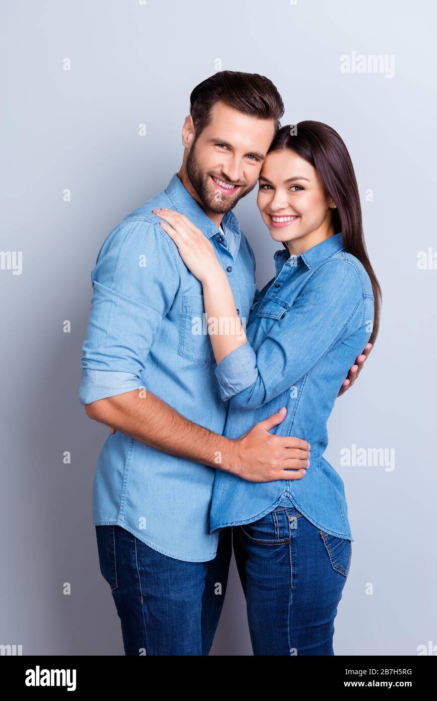 Vertical photo of two young cheerful people hugging each other against ...