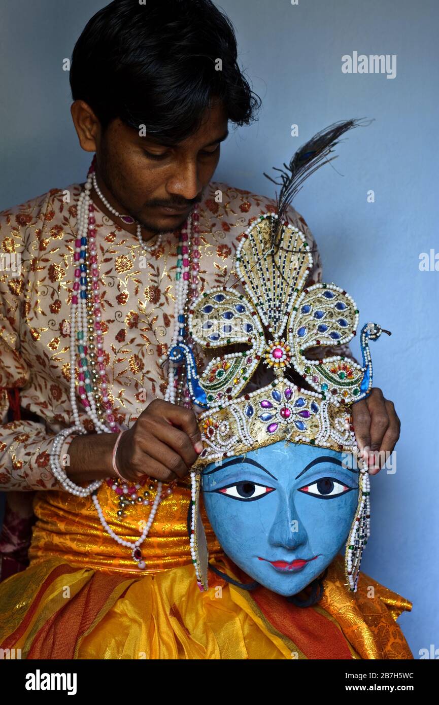Seraikela chhau dancer holding the mask of the hindu god Krishna ...