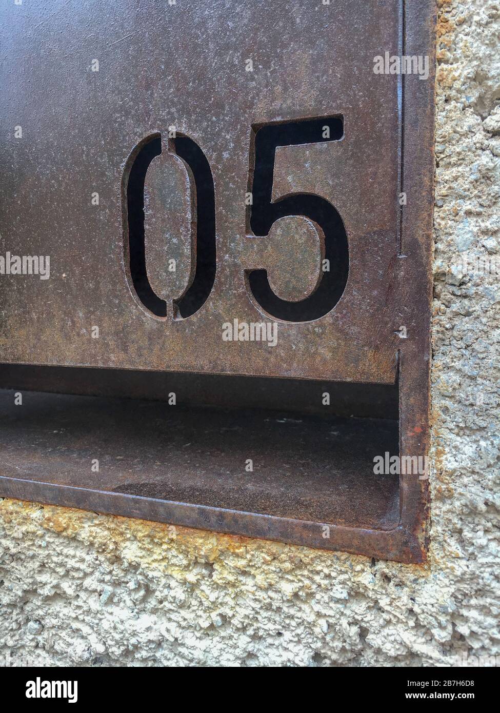 The number 05 embossed in metal and embedded in a wall Stock Photo - Alamy