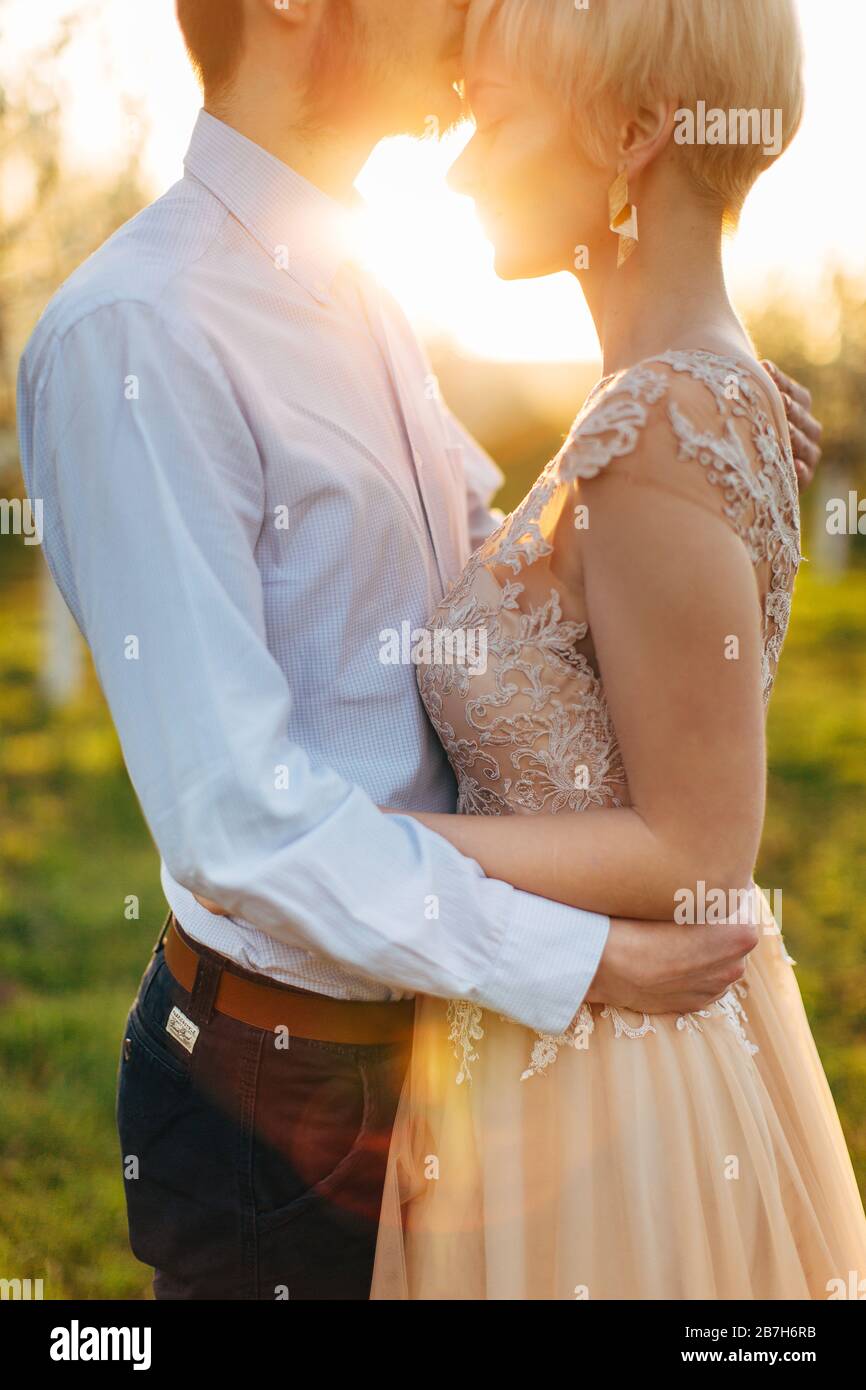 Cropped image of romantic couple hugging each other on the blooming ...