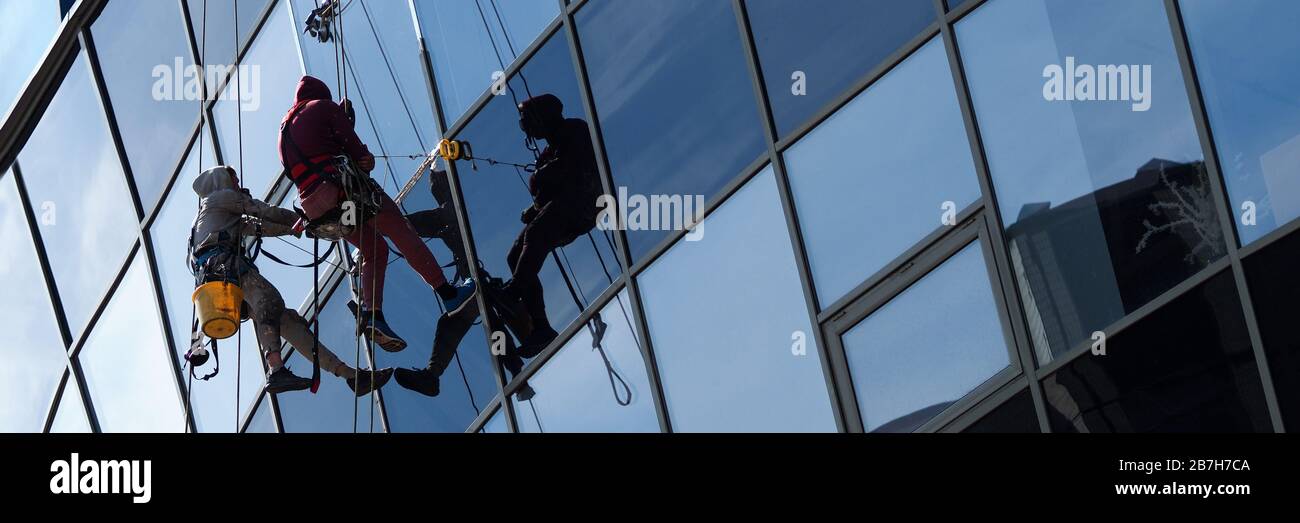 People professionally work at height wash windows Stock Photo - Alamy