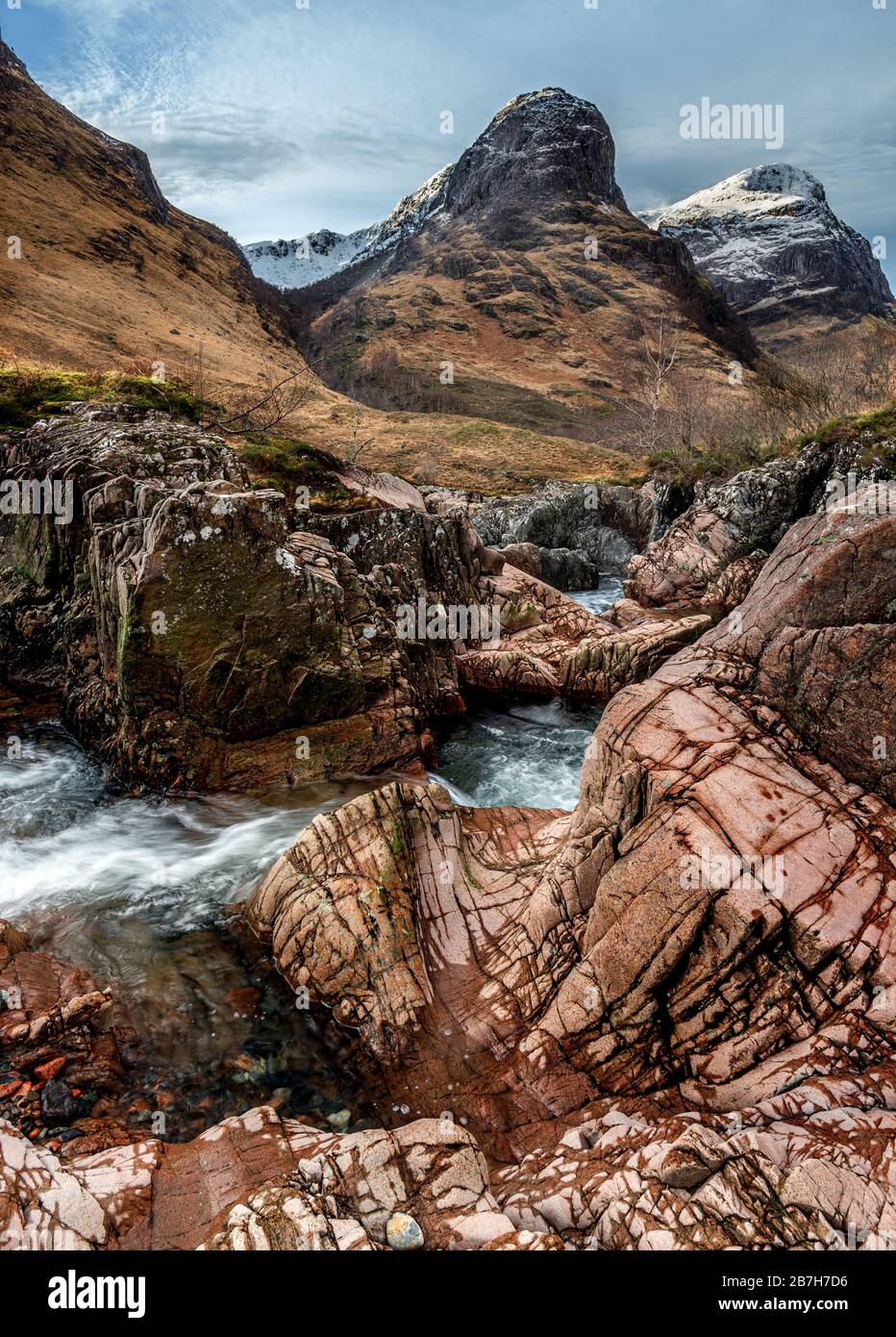 The River Coe flowing through Glen Coe in winter with the group of ...