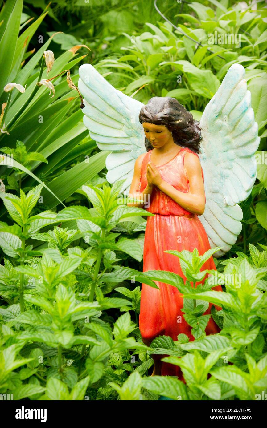 Praying Angel Statuette in Garden Stock Photo - Alamy