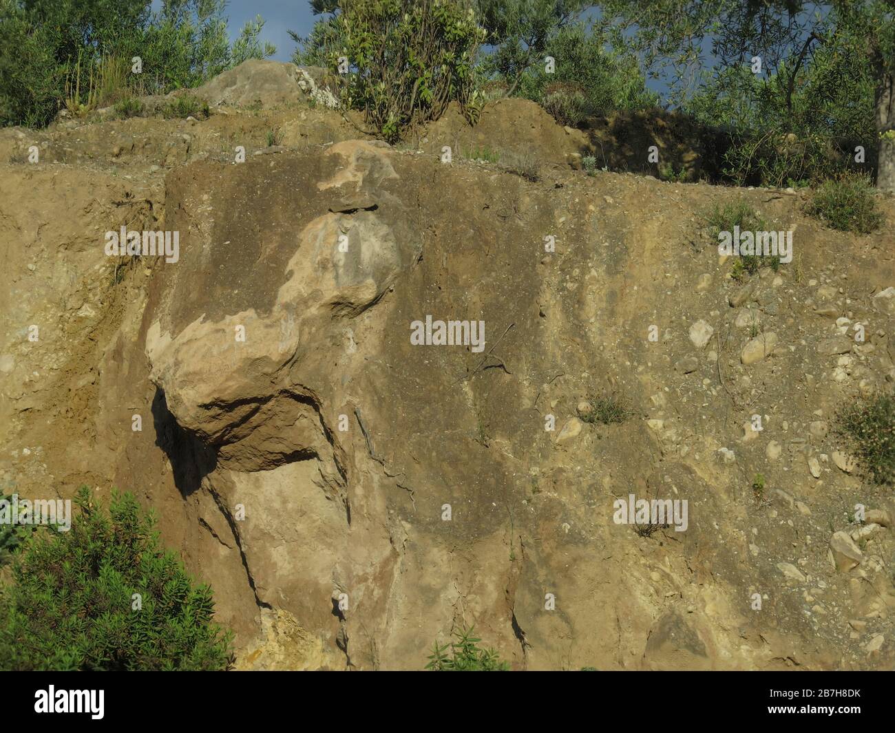 Rock face with big nose on roadside embankment near Andalusian Village ...