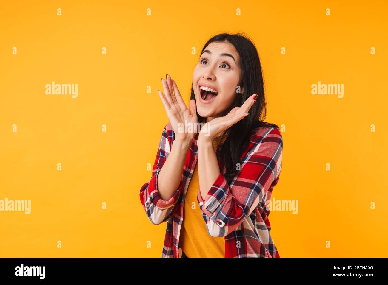 Photo of delighted cute woman expressing surprise and looking upward ...