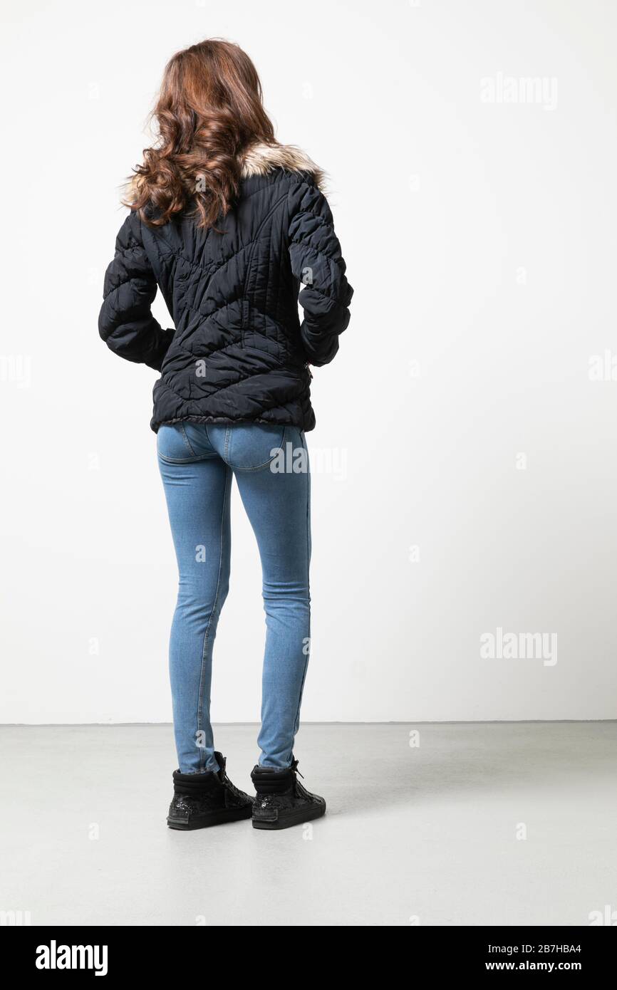 Woman seen from behind standing, whole body. White background Stock ...