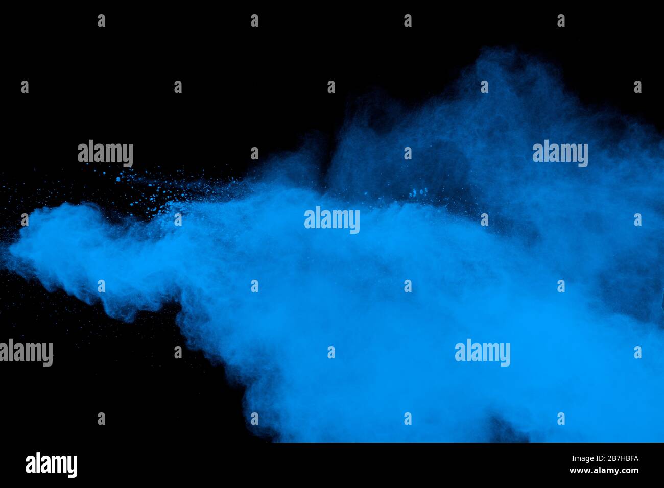 Blue dust explosion on black background. Freeze motion of color powder ...
