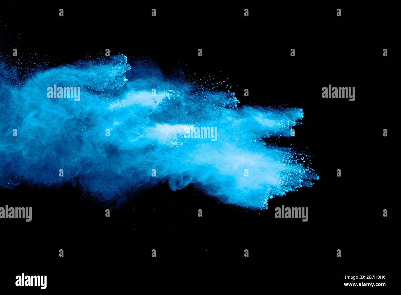 Blue dust explosion on black background. Freeze motion of color powder ...