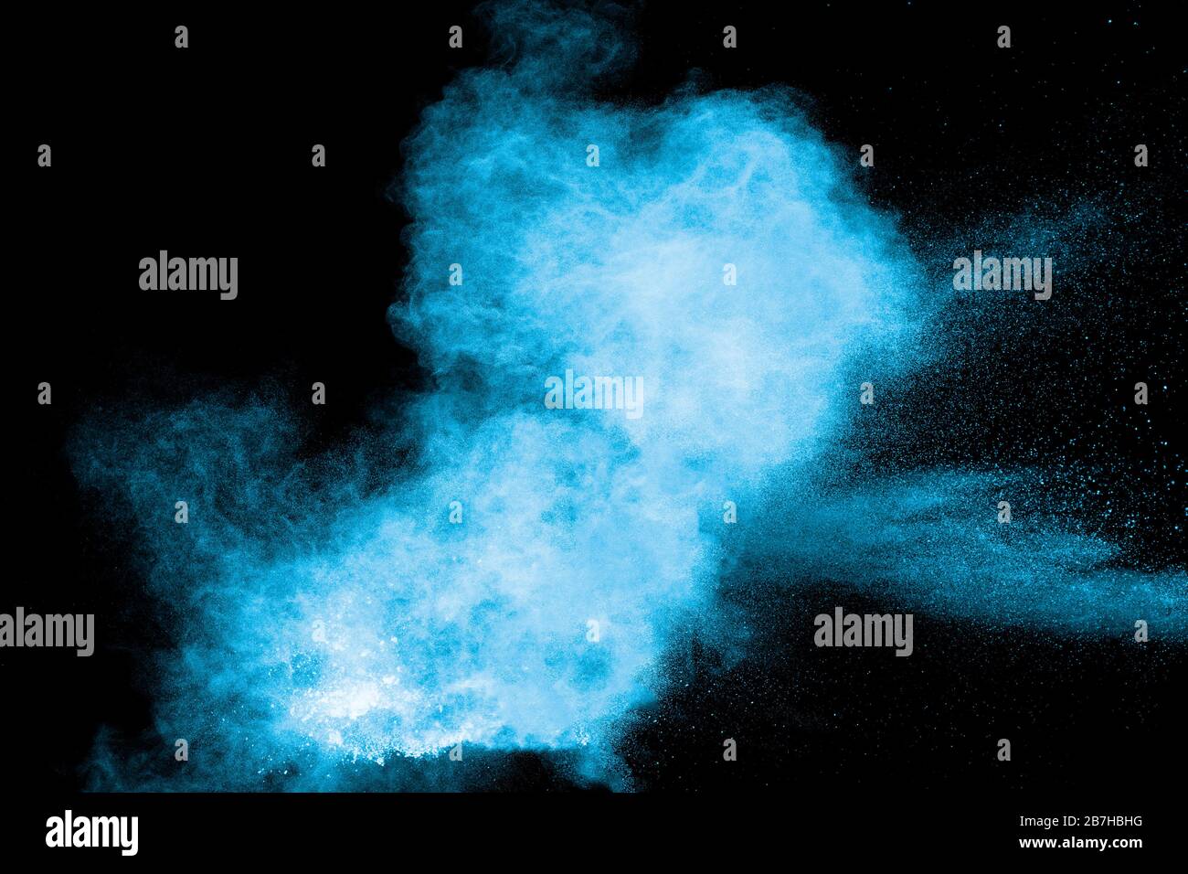 Blue dust explosion on black background. Freeze motion of color powder ...