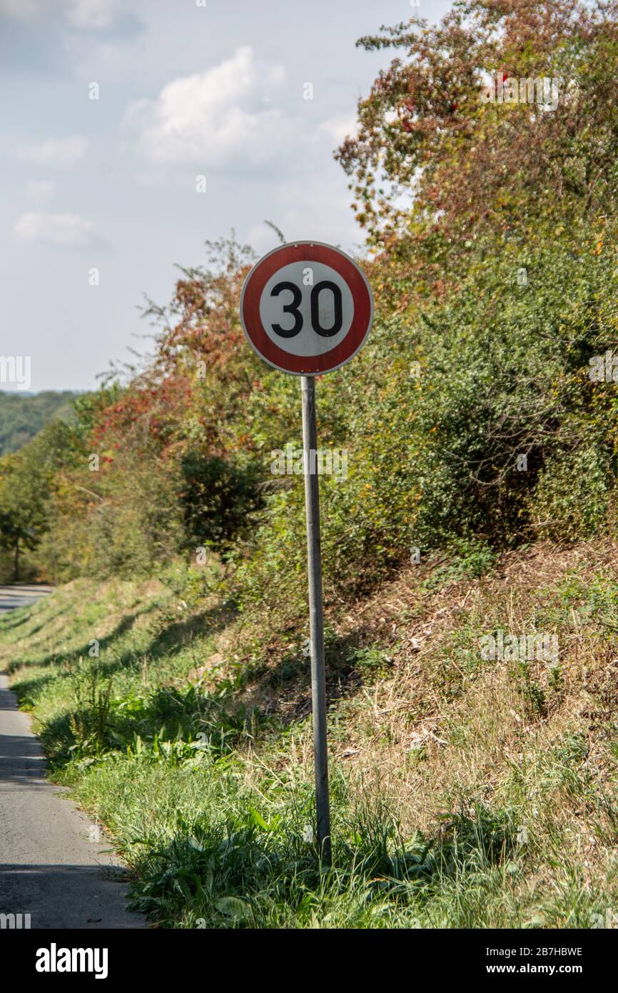 Road sign at 30 km / h along the way Stock Photo - Alamy