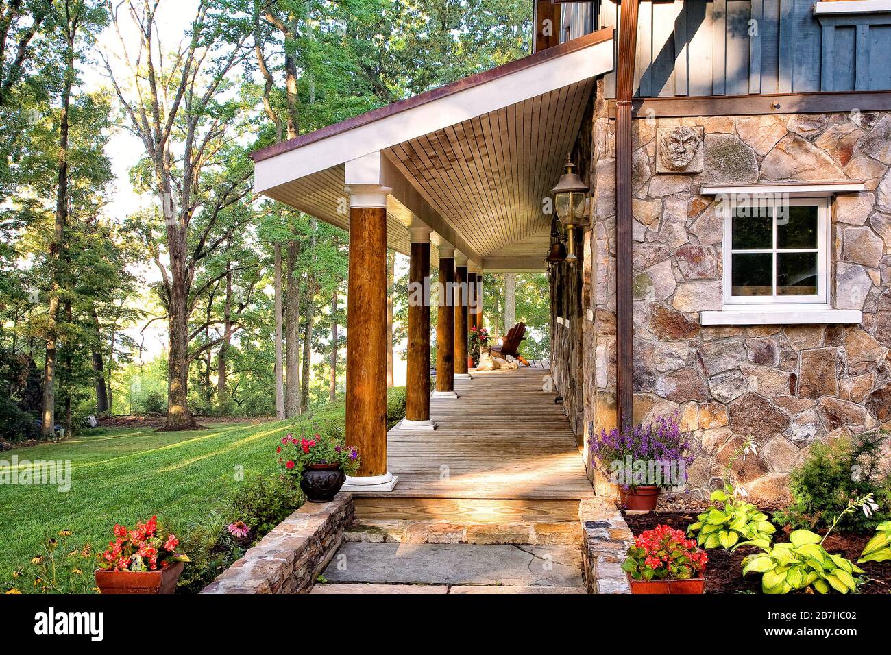 Long porch, thick wood columns Stock Photo - Alamy