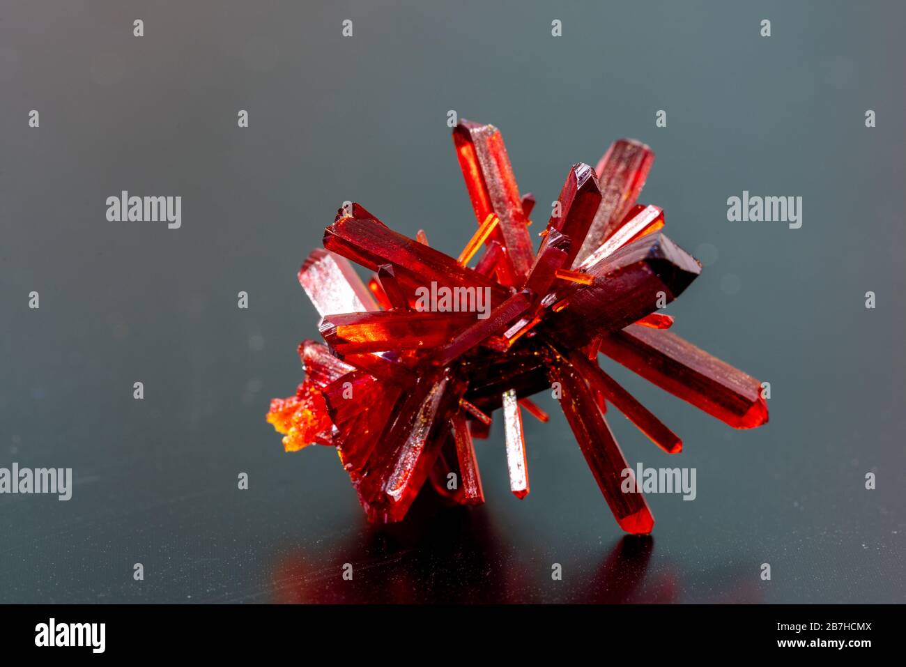 Red crystalline minerals on a black background Stock Photo - Alamy