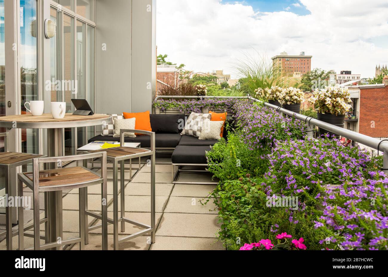Urban balcony garden, seating Stock Photo - Alamy