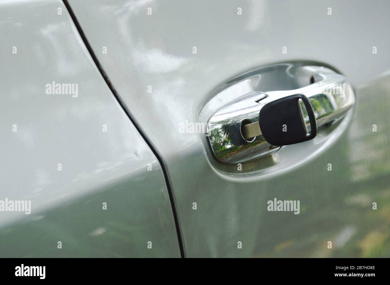 car key stabbing in handle hole for open door Stock Photo - Alamy