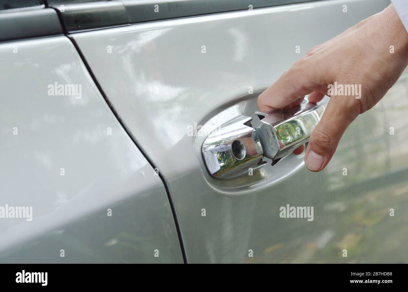 car door handle opened by hand down and pulling Stock Photo - Alamy
