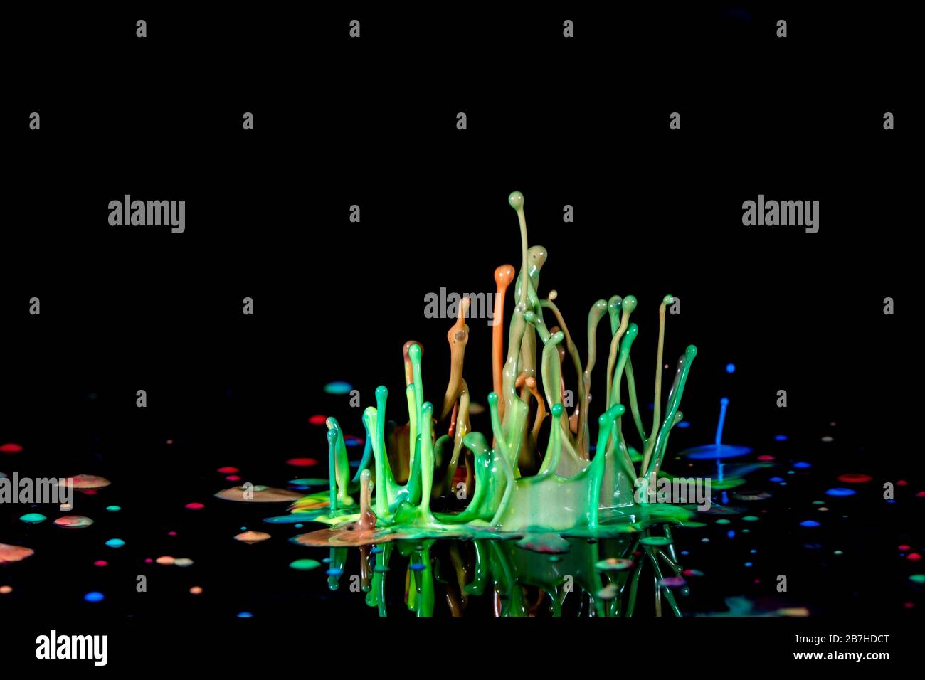 Splash of green ink on black background, abstract illustration of a ...