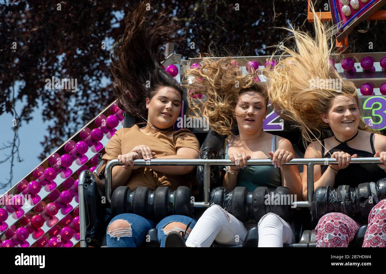 The flying hair of teenage girls on a fun fair ride Stock Photo - Alamy
