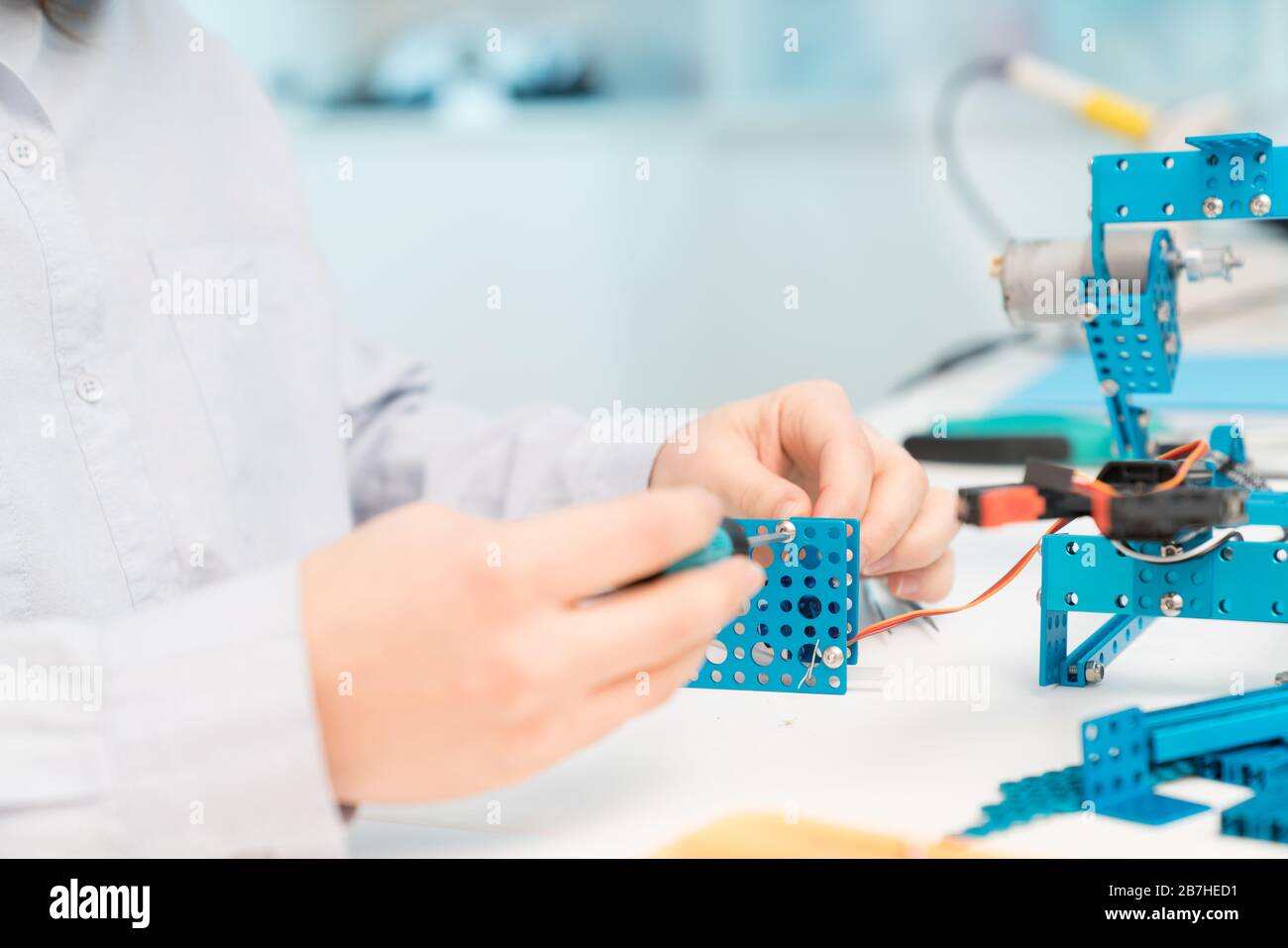 Student woman in robotics laboratory working on project mechatronics ...