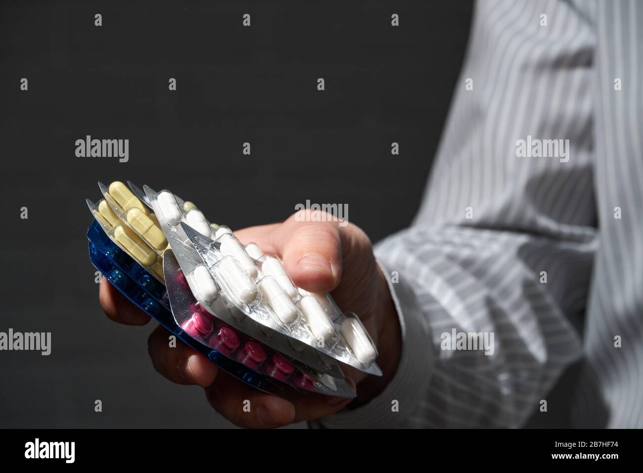 Businessman closeup portrait, he standing and posing with pills, health ...