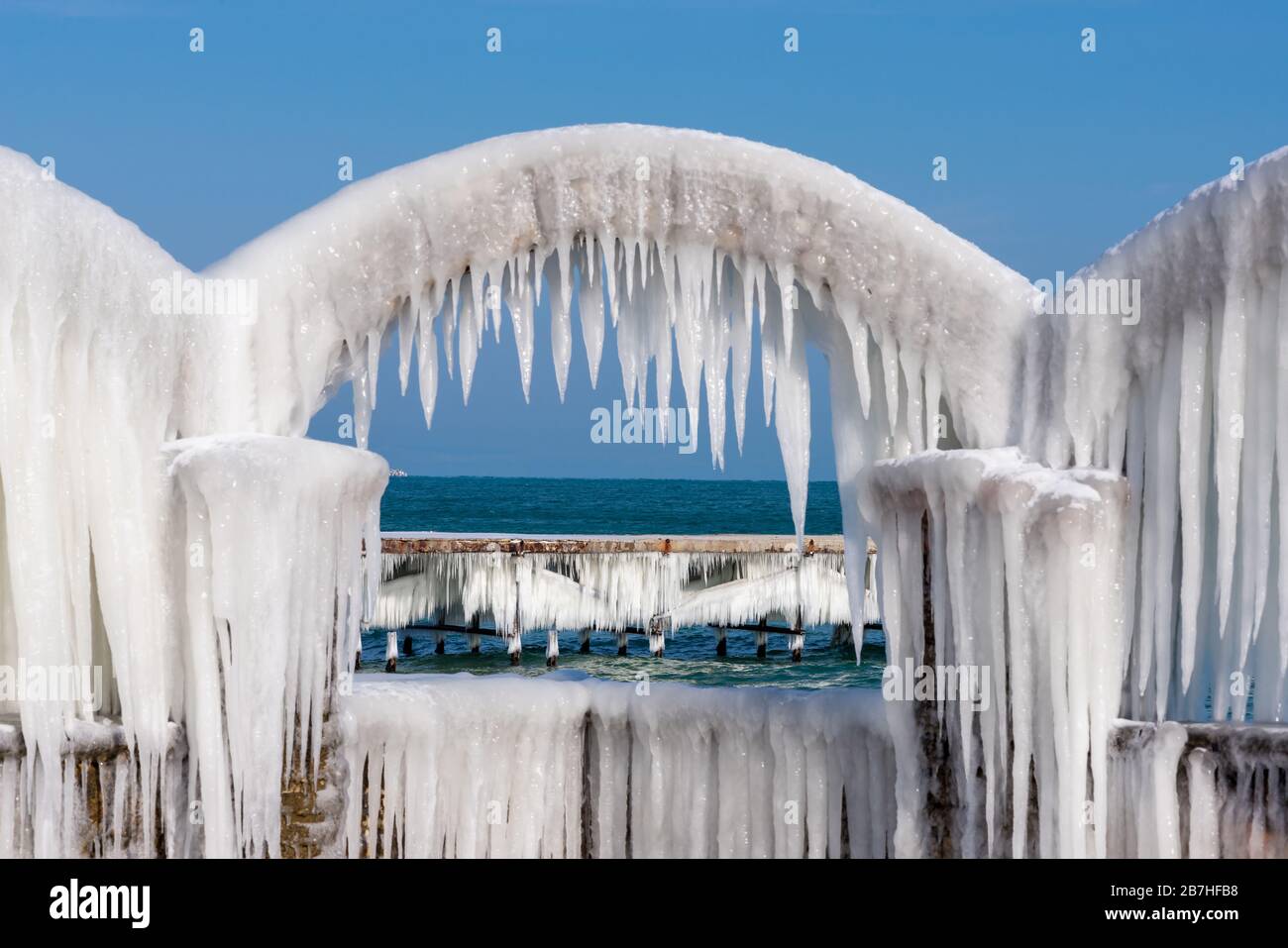Icicles over the arches of the abandoned swimming pool by the sea Stock ...
