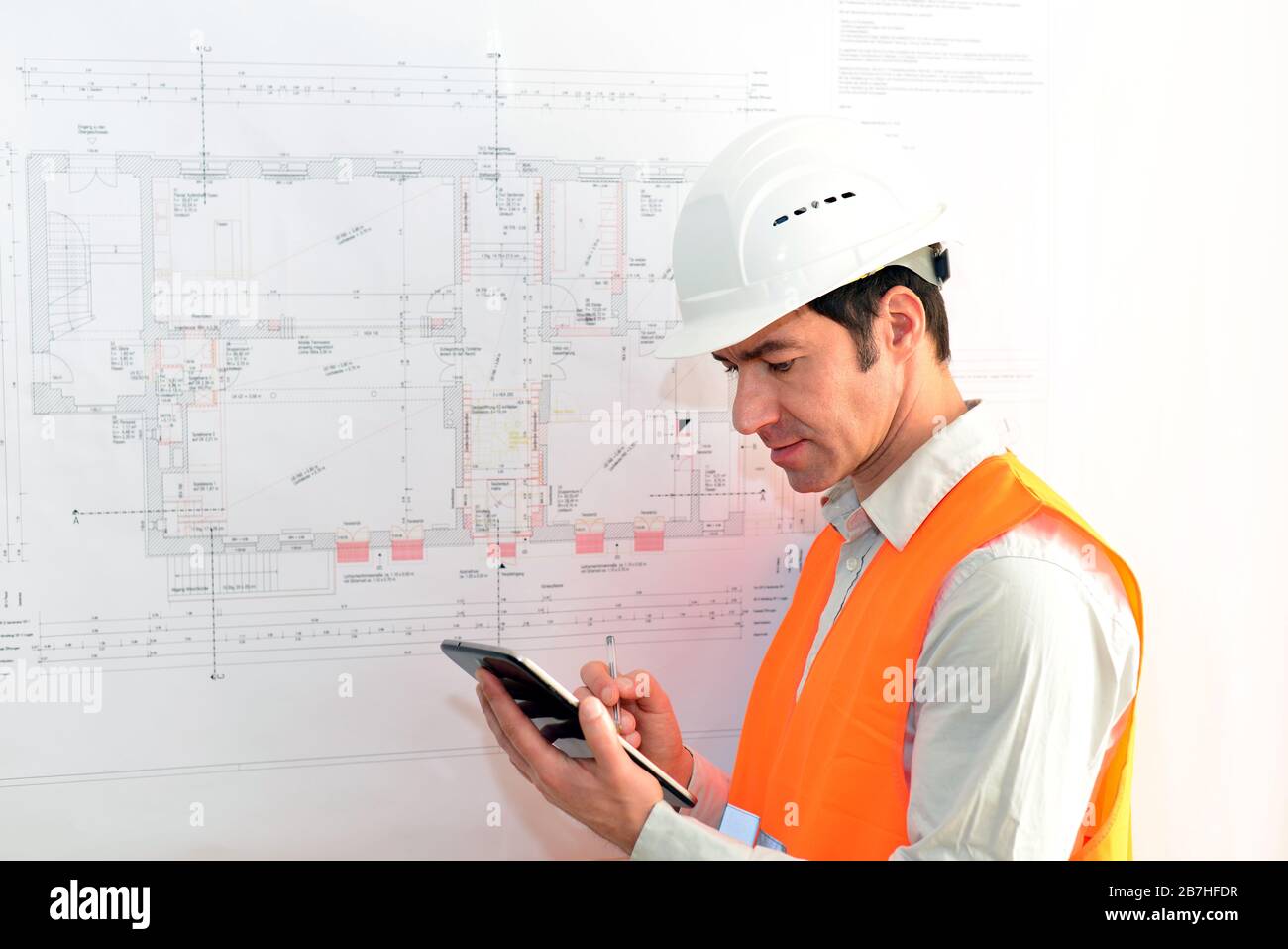architect planning a house on the ground plan Stock Photo - Alamy