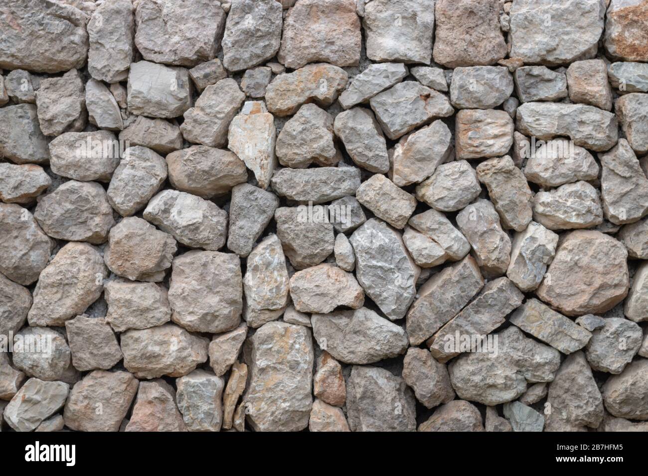 Wall made of bright stones without mortar Stock Photo - Alamy