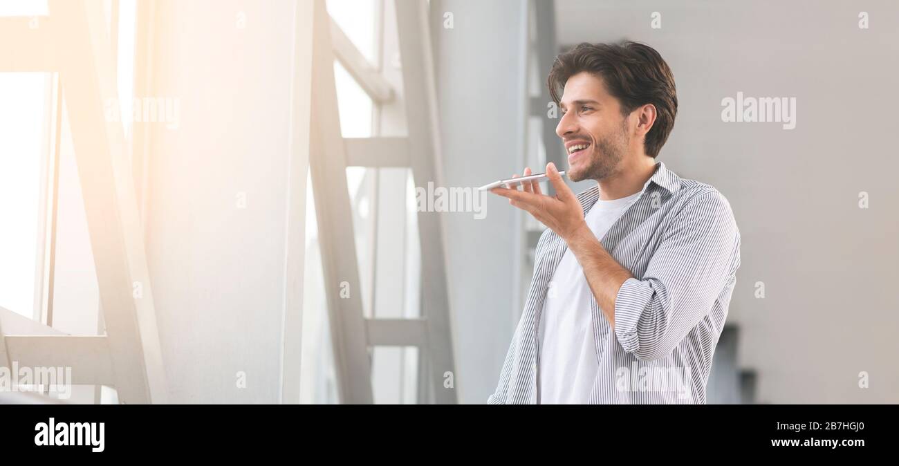 Travel Devices Concept. Man Using Voice Assistant On Smartphone In ...