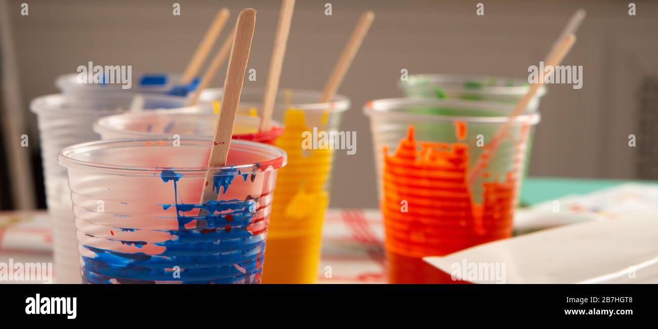 Artist acrylic colours in plastic cups in art studio Stock Photo - Alamy