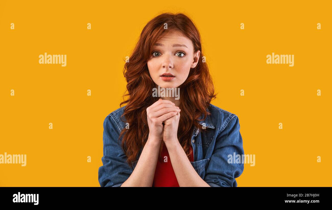 Girl Begging Keeping Hands In Praying Gesture Over Yellow Background ...