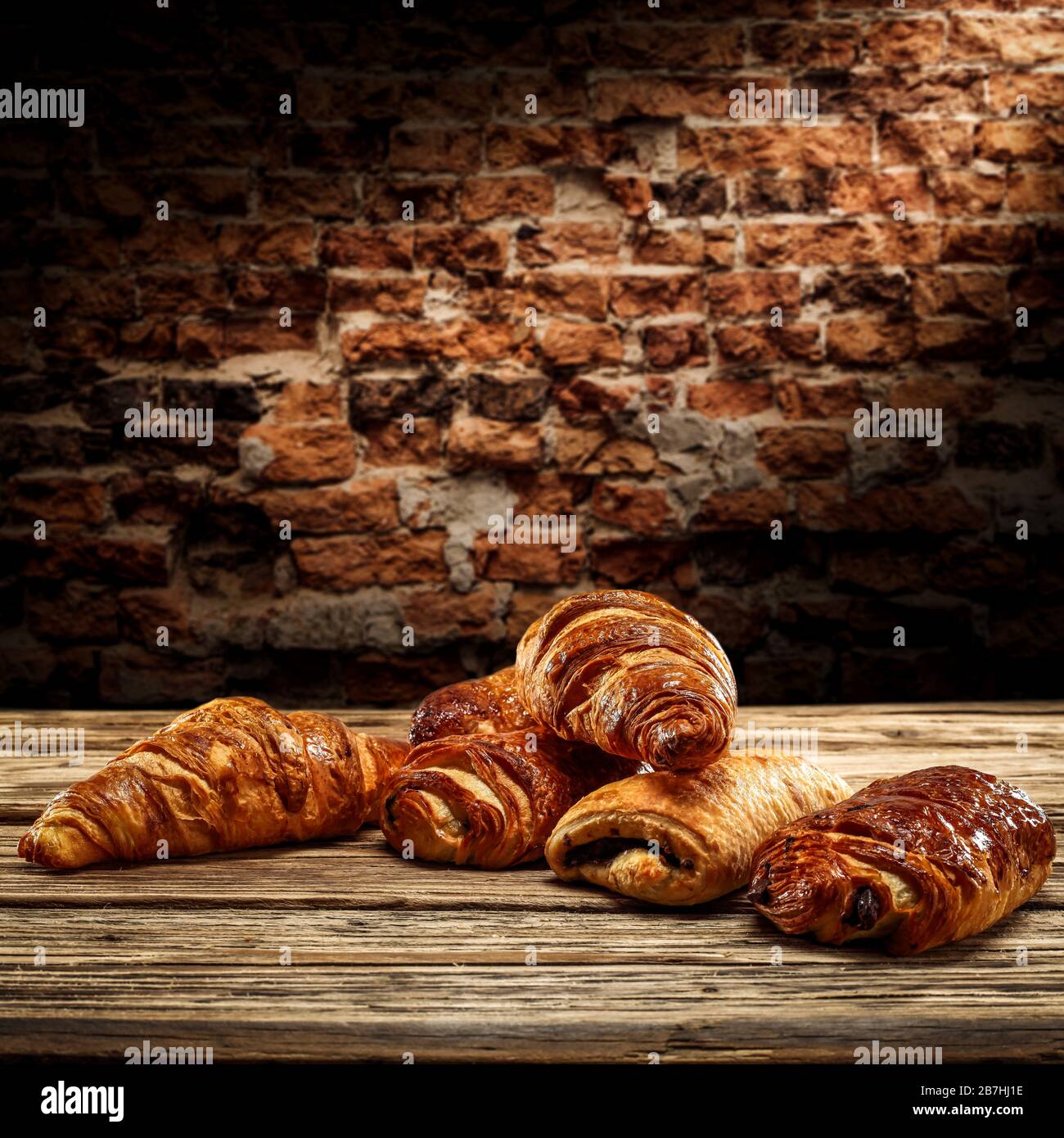 Fresh croissants on desk and free space for your decoration.Dark mood ...