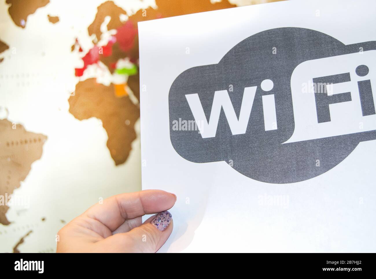 Wi-fi zone symbol in a woman's hand, access point on the background of ...