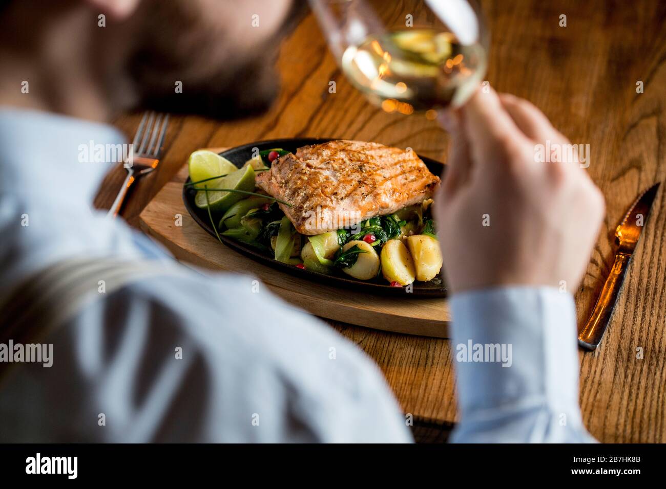 Young man eating fresh fish hi-res stock photography and images - Alamy