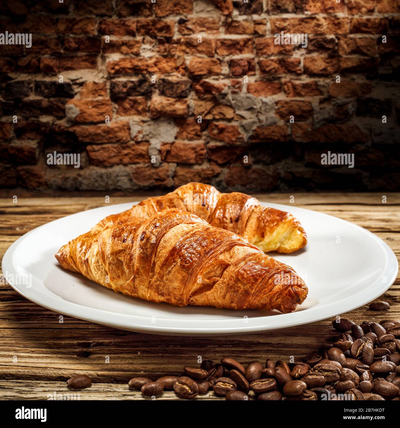 Fresh croissants on desk and free space for your decoration.Dark mood ...