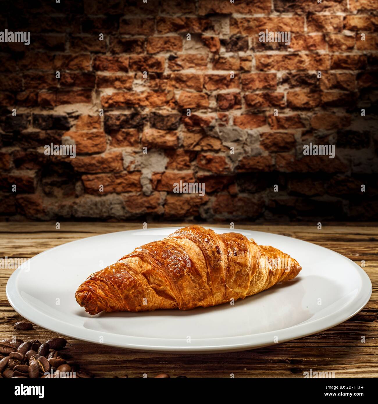 Fresh croissants on desk and free space for your decoration.Dark mood ...