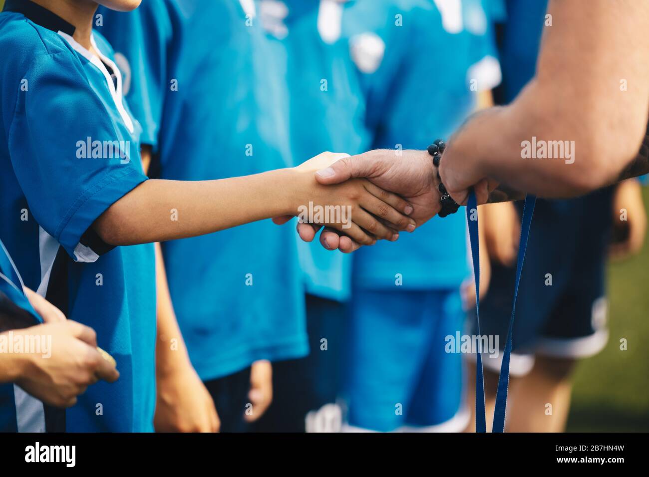 Soccer handshake during ceremony. Kids getting awarded with golden ...