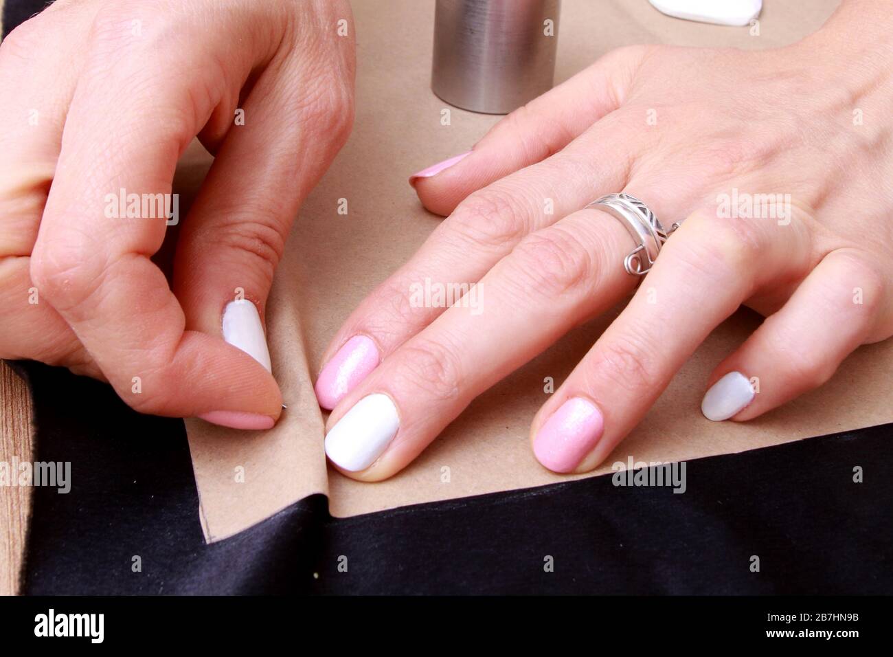 Woman's hands with cloth. Female hands with fabric securing cut fabric ...