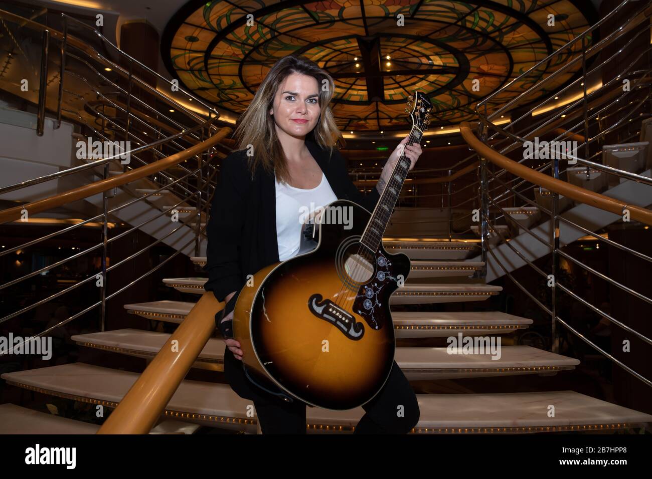 Angela Grace Brown, singer and guitarist, posing in the atrium onboard ...