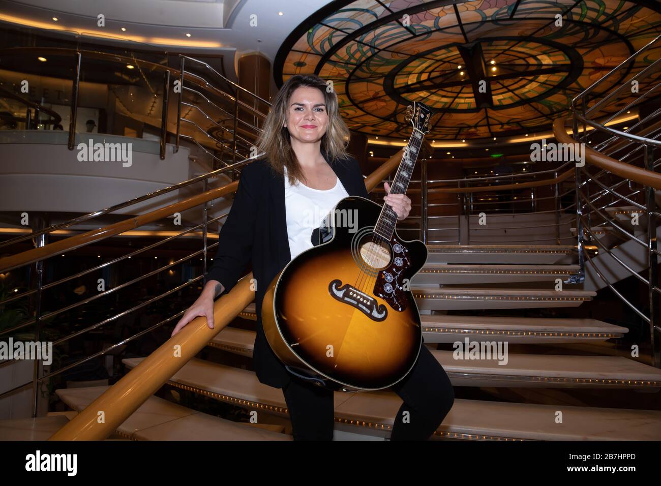 Angela Grace Brown, singer and guitarist, posing in the atrium onboard ...