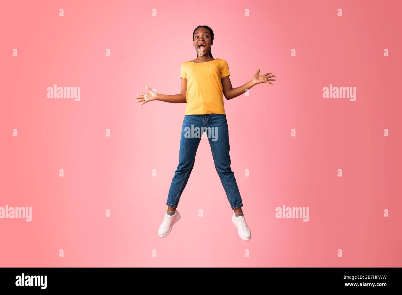 Excited Millennial Girl Jumping And Shouting Over Pink Background Stock ...