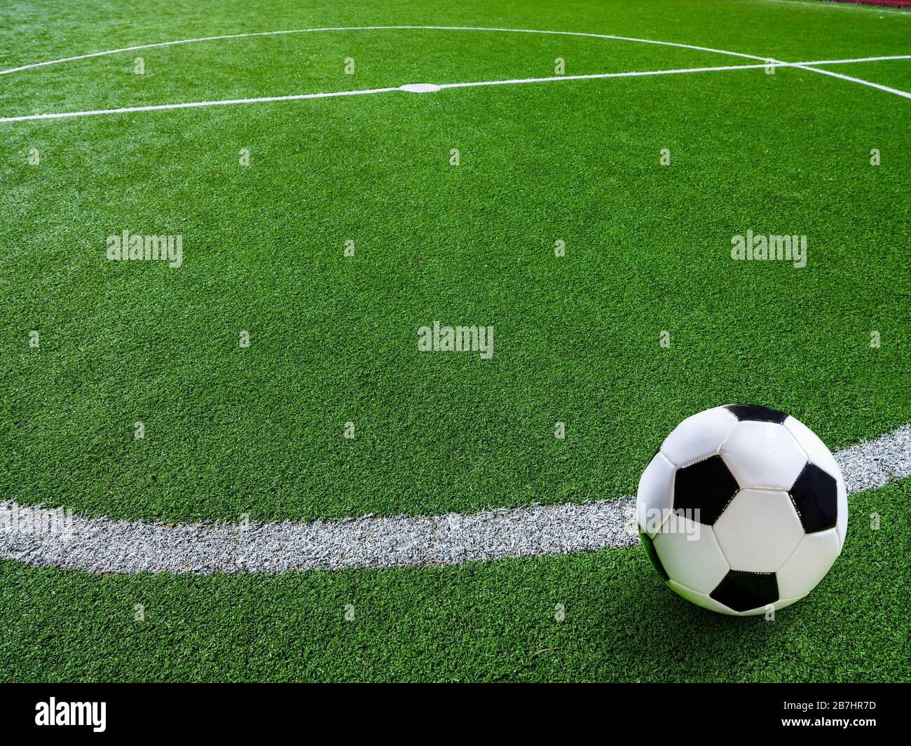 Soccer ball on the grass of a soccer field Stock Photo - Alamy