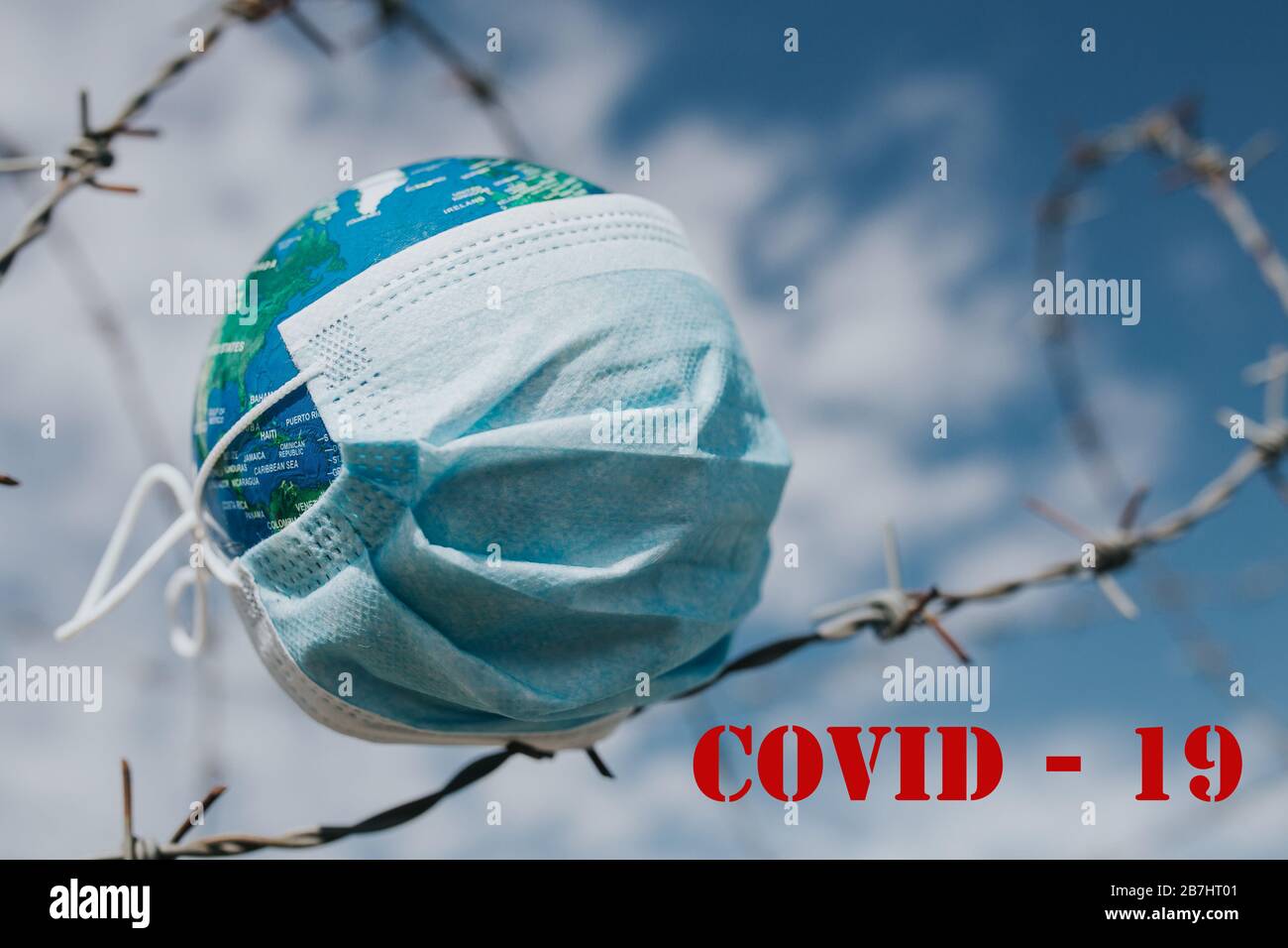 Surgical mask on Earth globe. Epidemics concept. World infected with ...