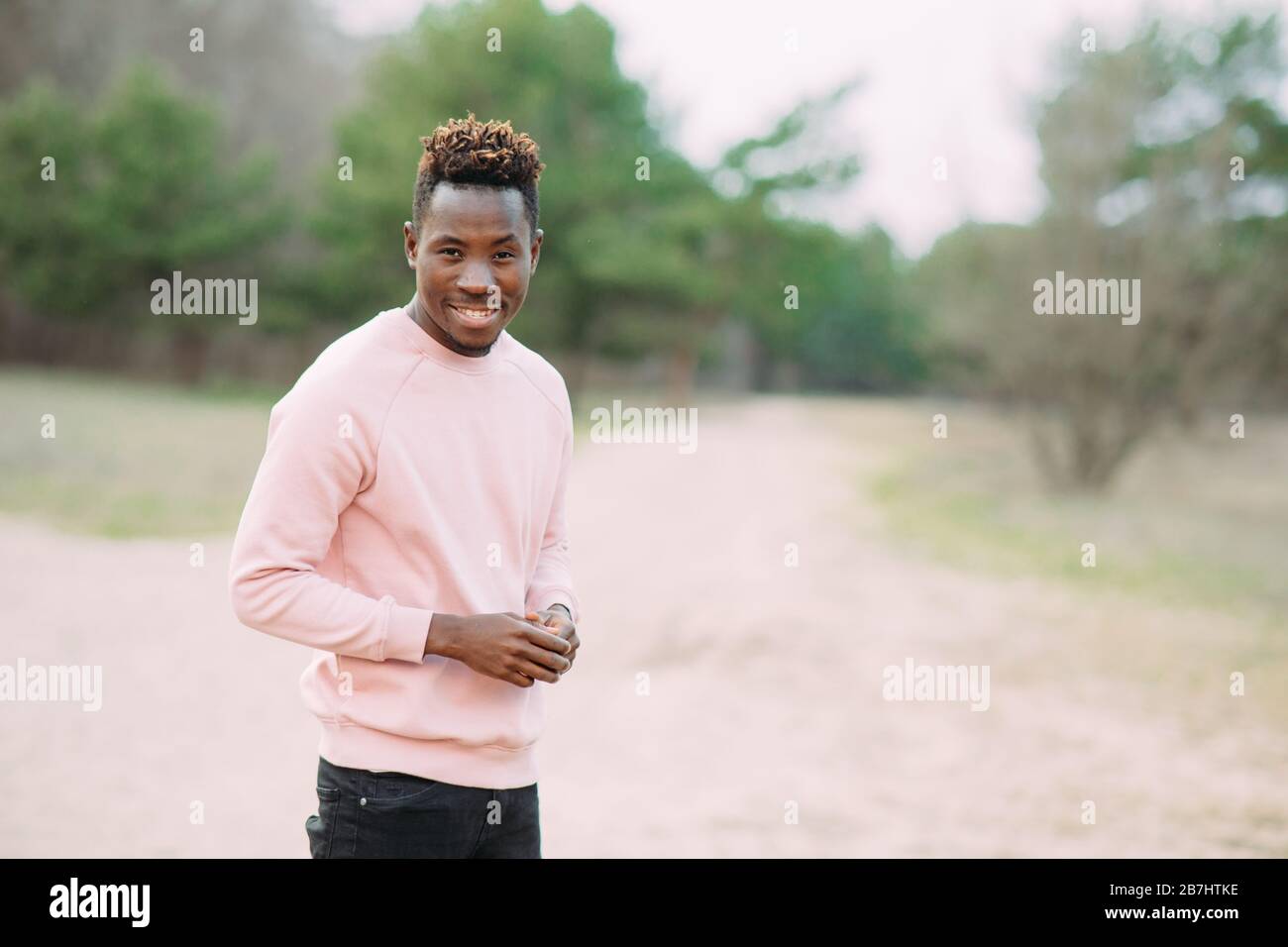 Happy african man stands hi-res stock photography and images - Alamy
