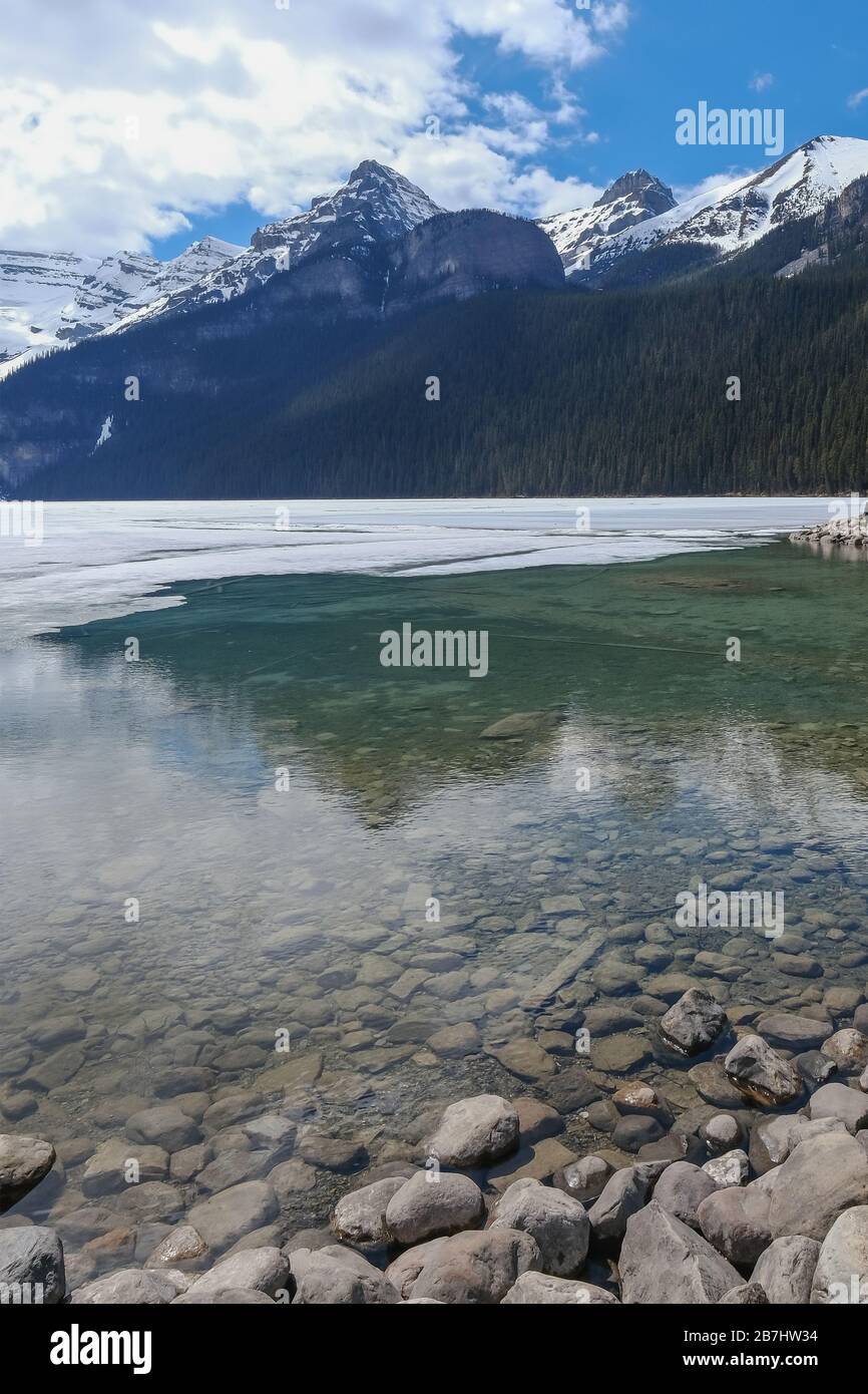 Mount fairview, partly frozen lake, with reflection in water. Lake ...