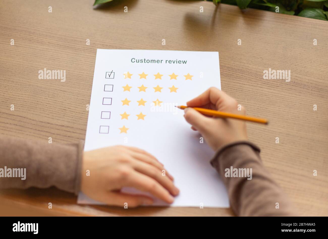 Woman hand point at five star rating on paper sheet Stock Photo - Alamy