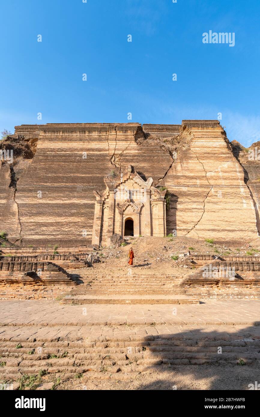 Buddhist monk walking past the south entrance of the Mingun Pahtodawgyi ...