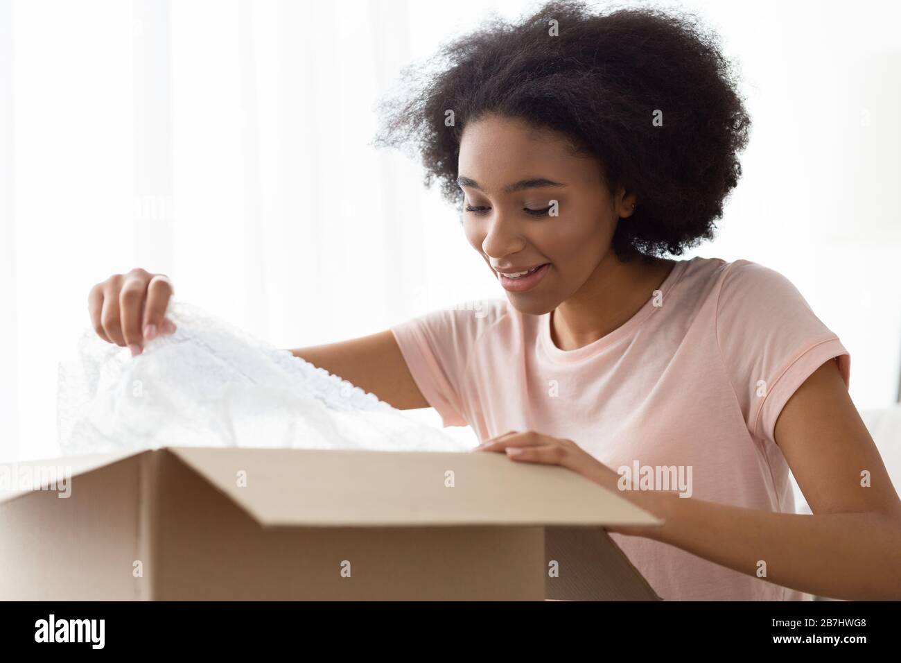 African american customer remove packaging from purchase Stock Photo ...