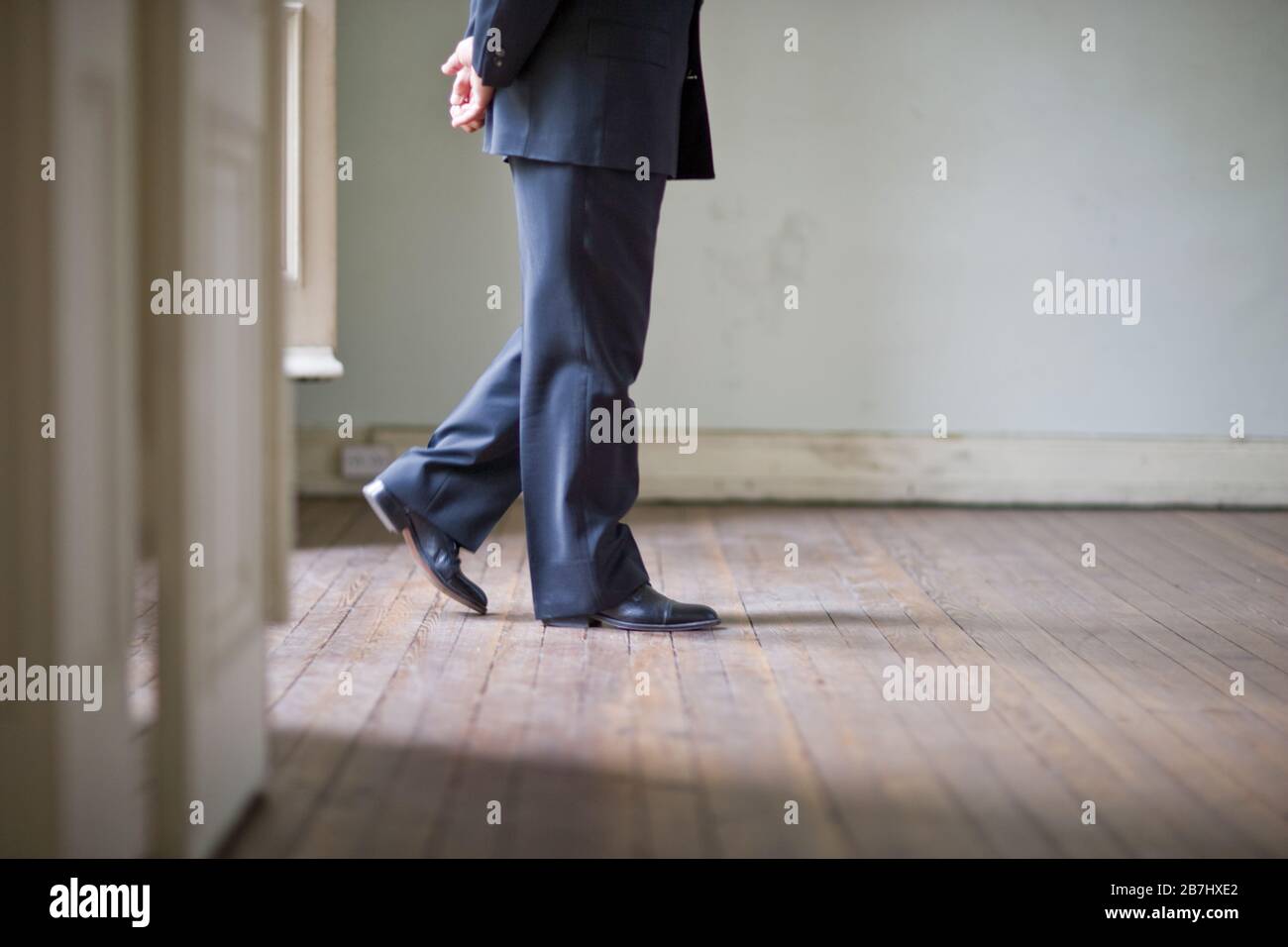 Legs of a man walking into a room Stock Photo - Alamy