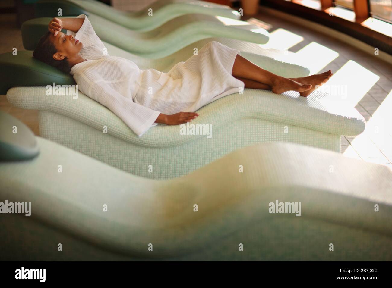 Woman lying on massage chair in spa treatment room Stock Photo - Alamy