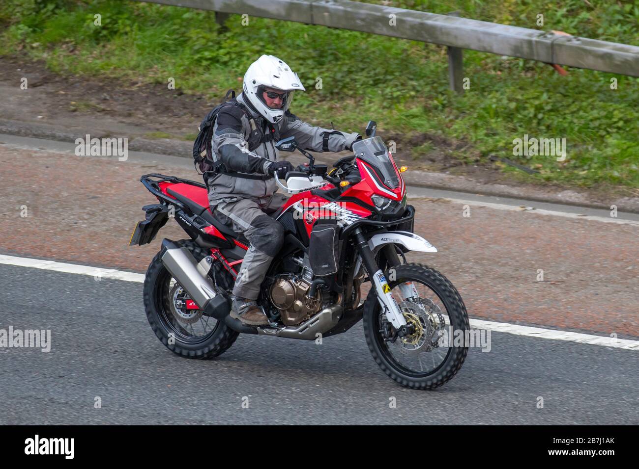 Honda Africa Twin motorcycle rider; Vehicular traffic, two wheeled ...