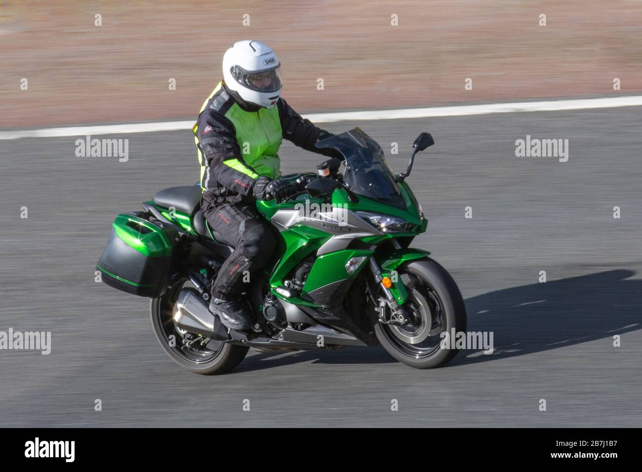 Green Kawasaki z1000 motorcycle rider; Vehicular traffic, two wheeled ...